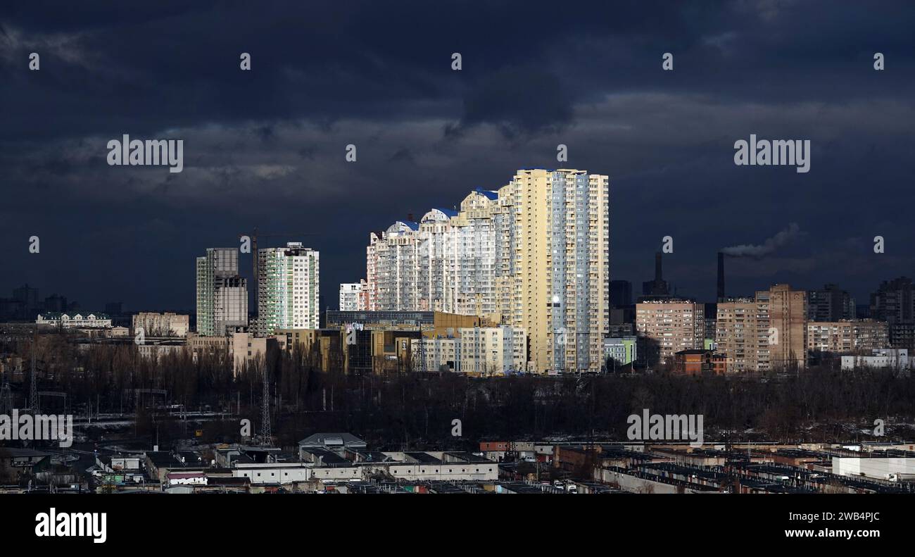 City block with high-rise buildings on a dark background of clouds of ...