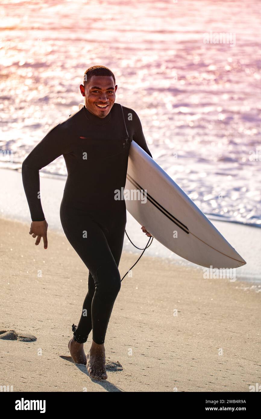 Man surfer run in the beach near the ocean with surfboard Stock Photo ...