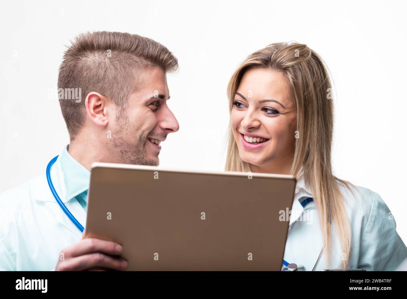 Medical teamwork is evident as the practitioners focus on electronic ...