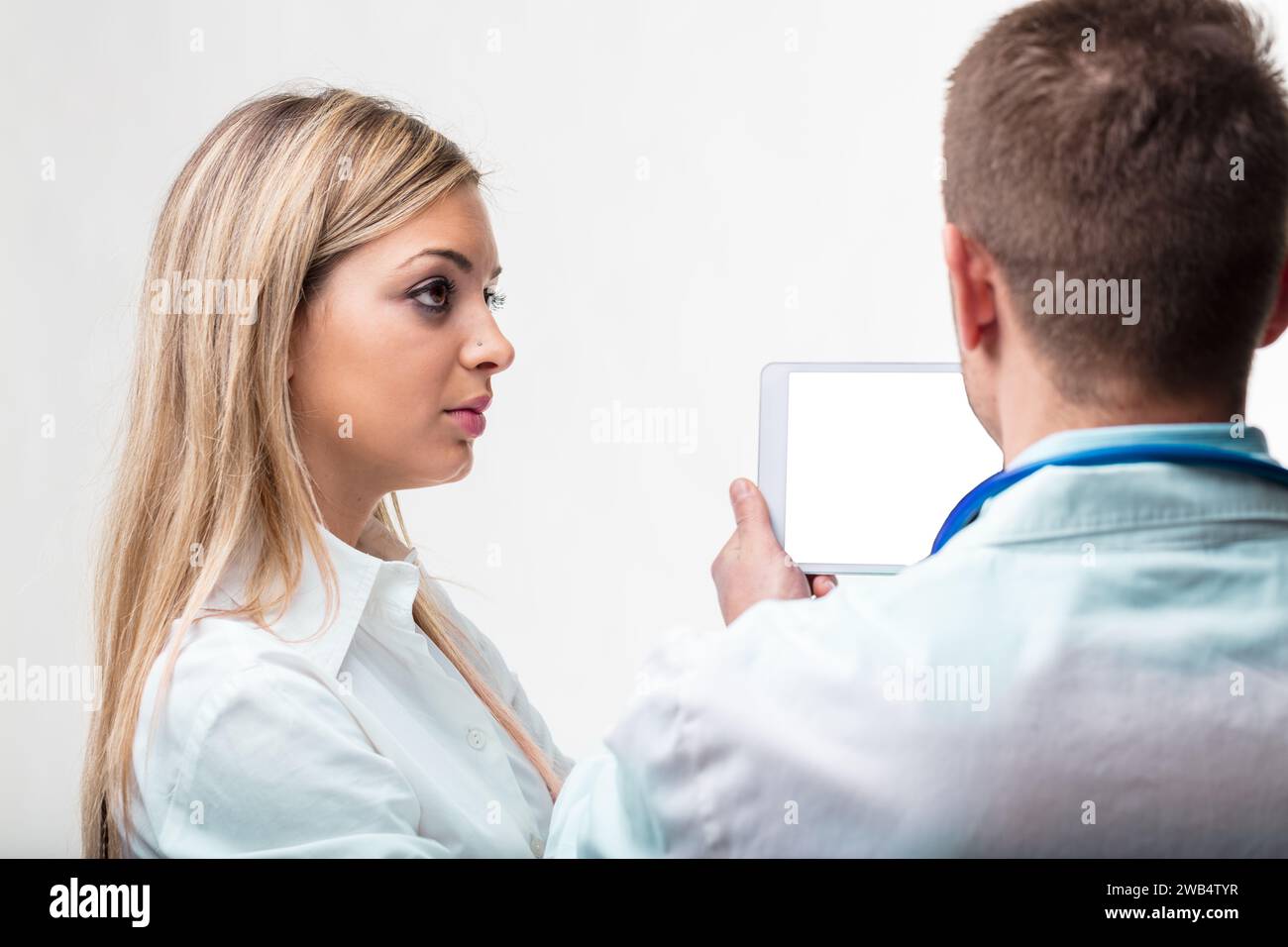 Engaging in a digital health review, the patient examines her medical ...