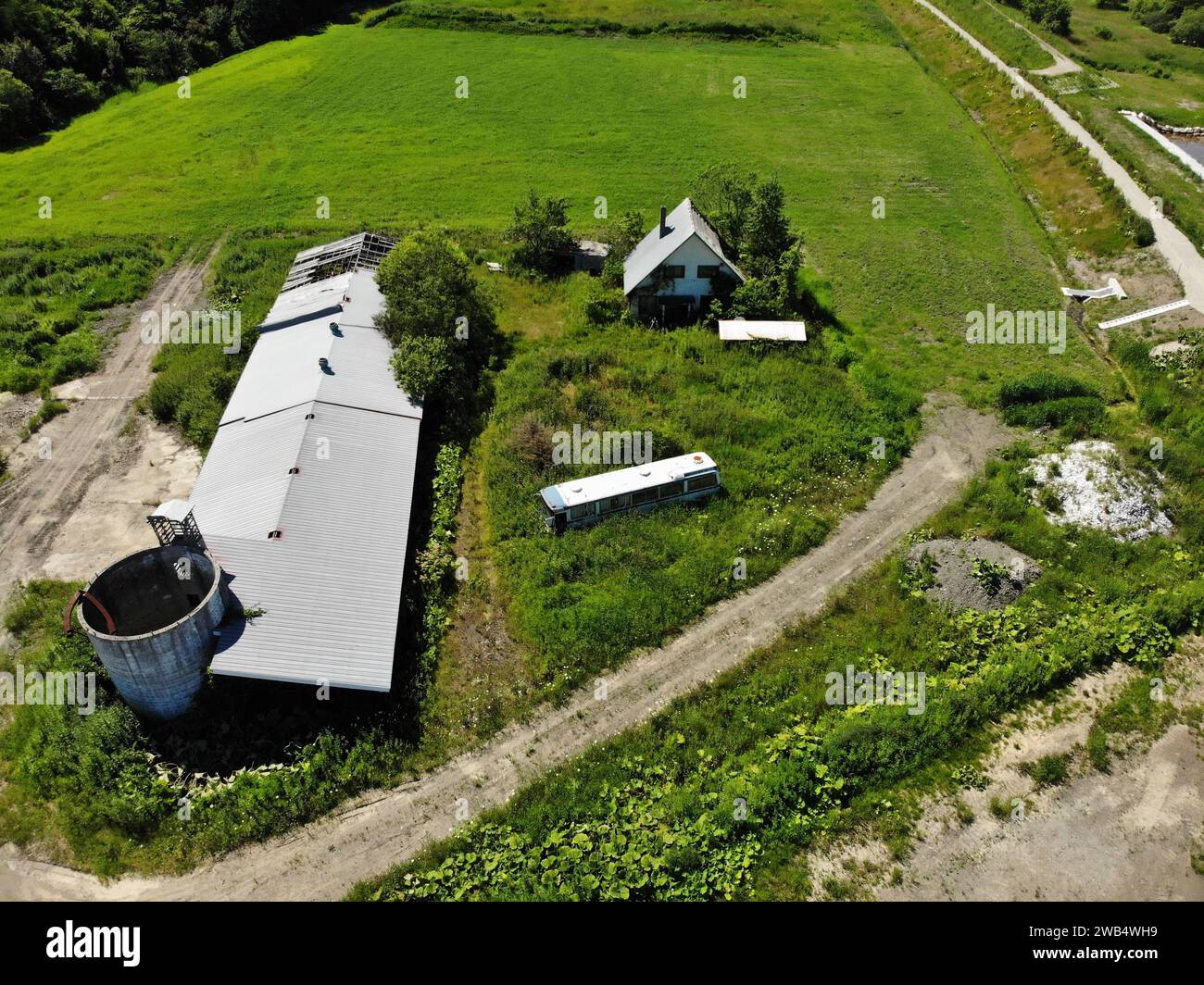 abandoned farm and bus, that are reclaimed by nature Stock Photo - Alamy