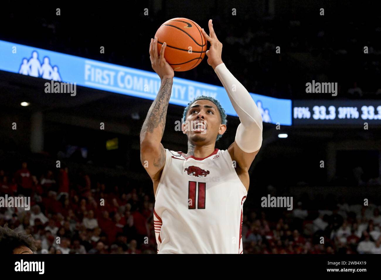 Arkansas forward Jalen Graham (11) shoots over an Auburn defender ...
