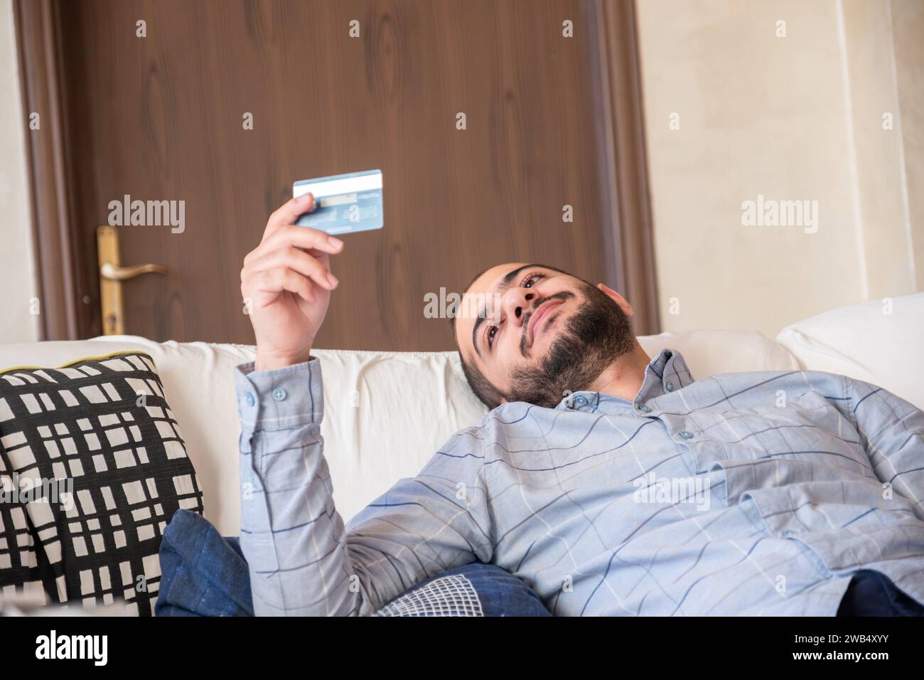 male holding bank card while feeling stressed due to financial issue ...