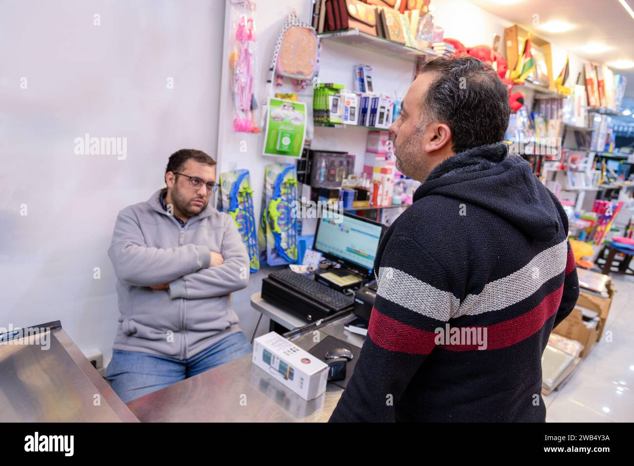 portrait for school shop owner sitting at the cashier chair Stock Photo ...