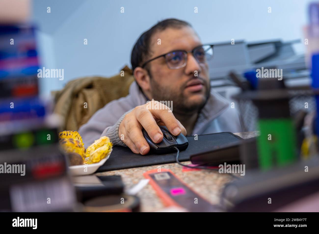 Book shop owner with printers in the background for printing services ...