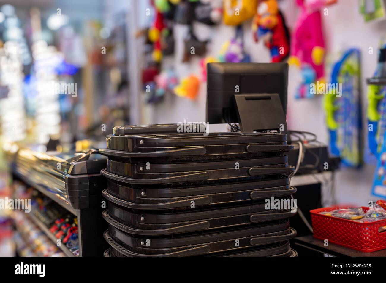 Shopping cart with cashier PC screen in the background for gift sore ...