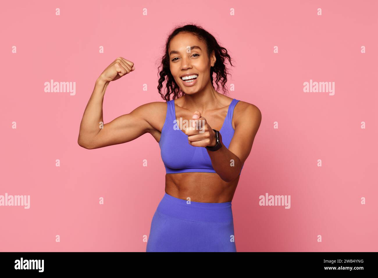 Athletic african woman showing biceps hi-res stock photography and ...