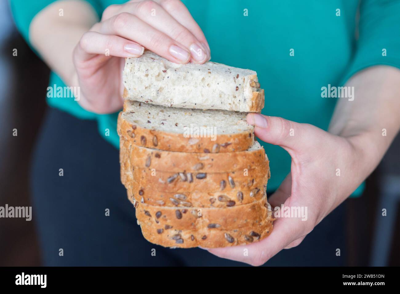 Woman's hands holding slices of bread close-up. The process of ...