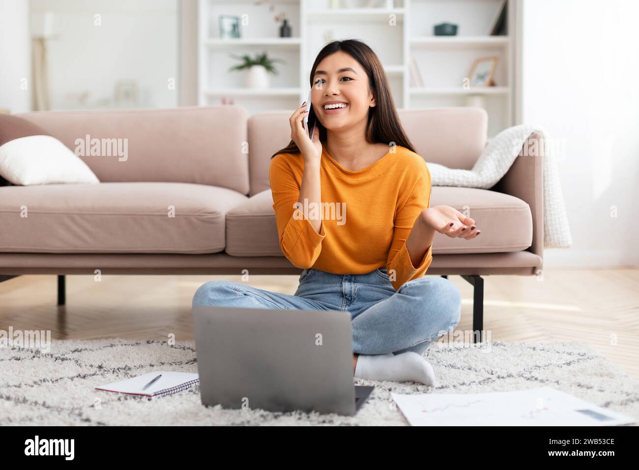 Young asian businesswoman working from home, have phone conversation ...