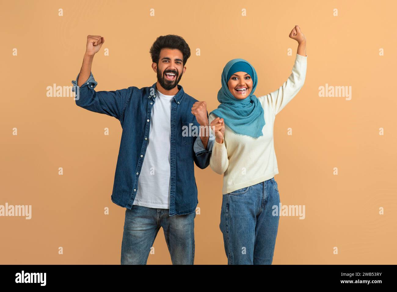 Joy Of Win. Happy Excited Muslim Couple Celebrating Success With Raised ...