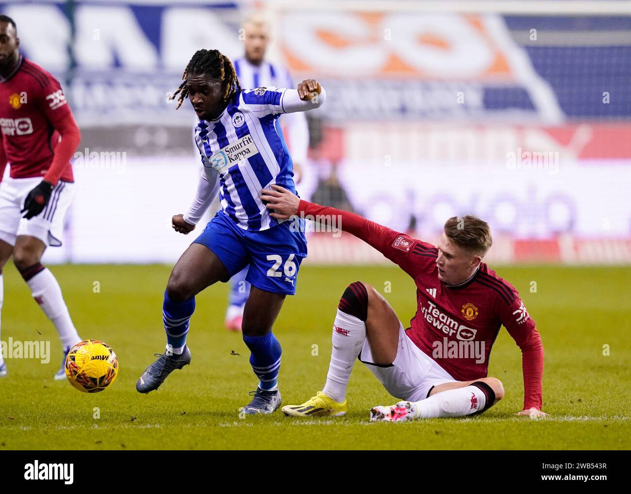 Wigan, UK. 8th Jan, 2024. Baba Adeeko of Wigan Athletic intercepts ...