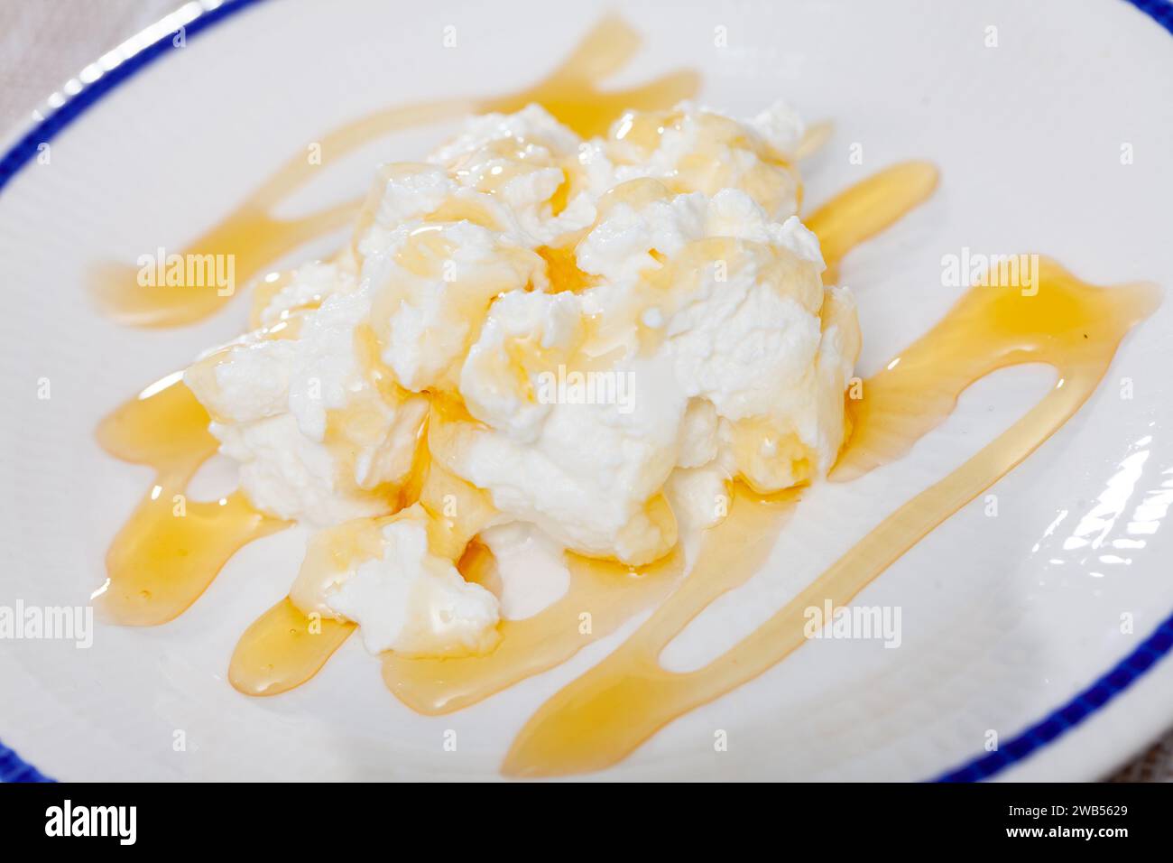 Soft whey cheese mato from goat milk with honey Stock Photo - Alamy