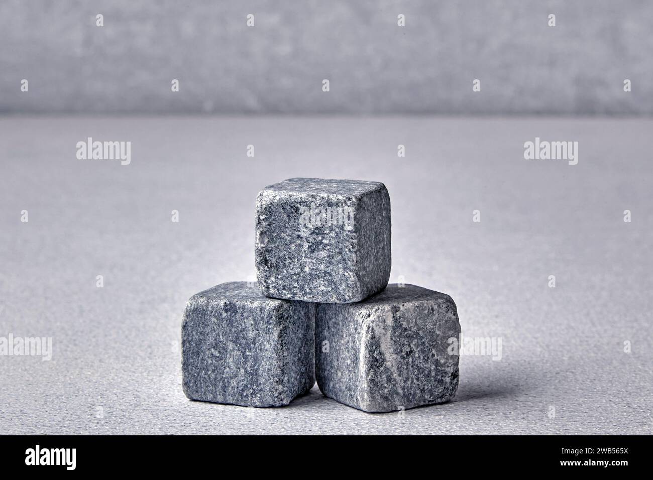 Three stone cubes on a gray concrete background. Backdrop template for ...