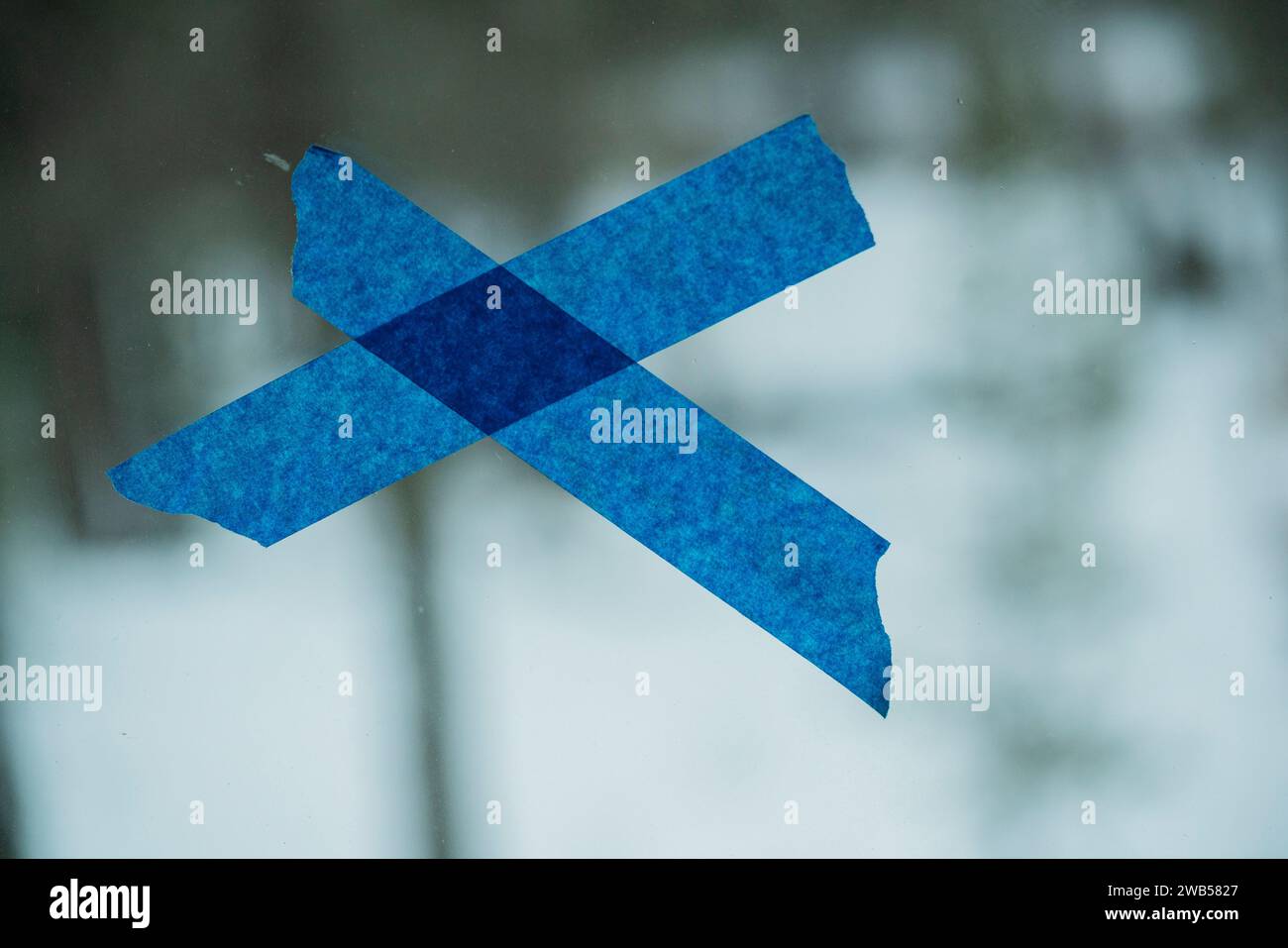 Blue tape on window during installation Stock Photo - Alamy