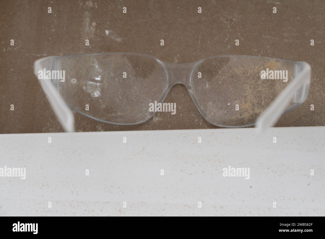 Used clear safety glasses at home construction job site Stock Photo - Alamy