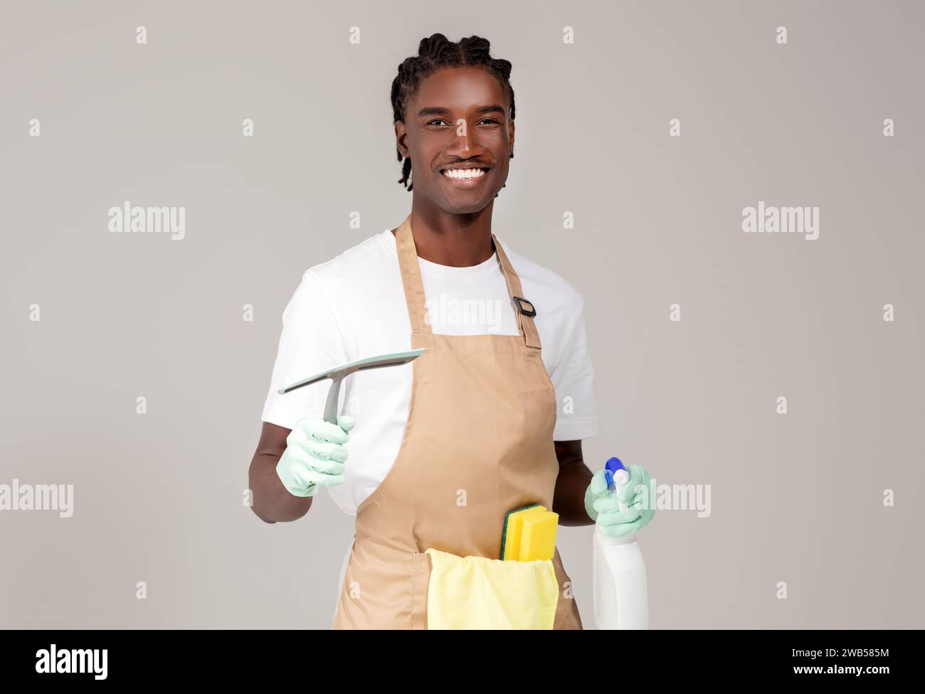 Cleaning Services. Handsome Black Cleaner Man Posing With Detergents ...