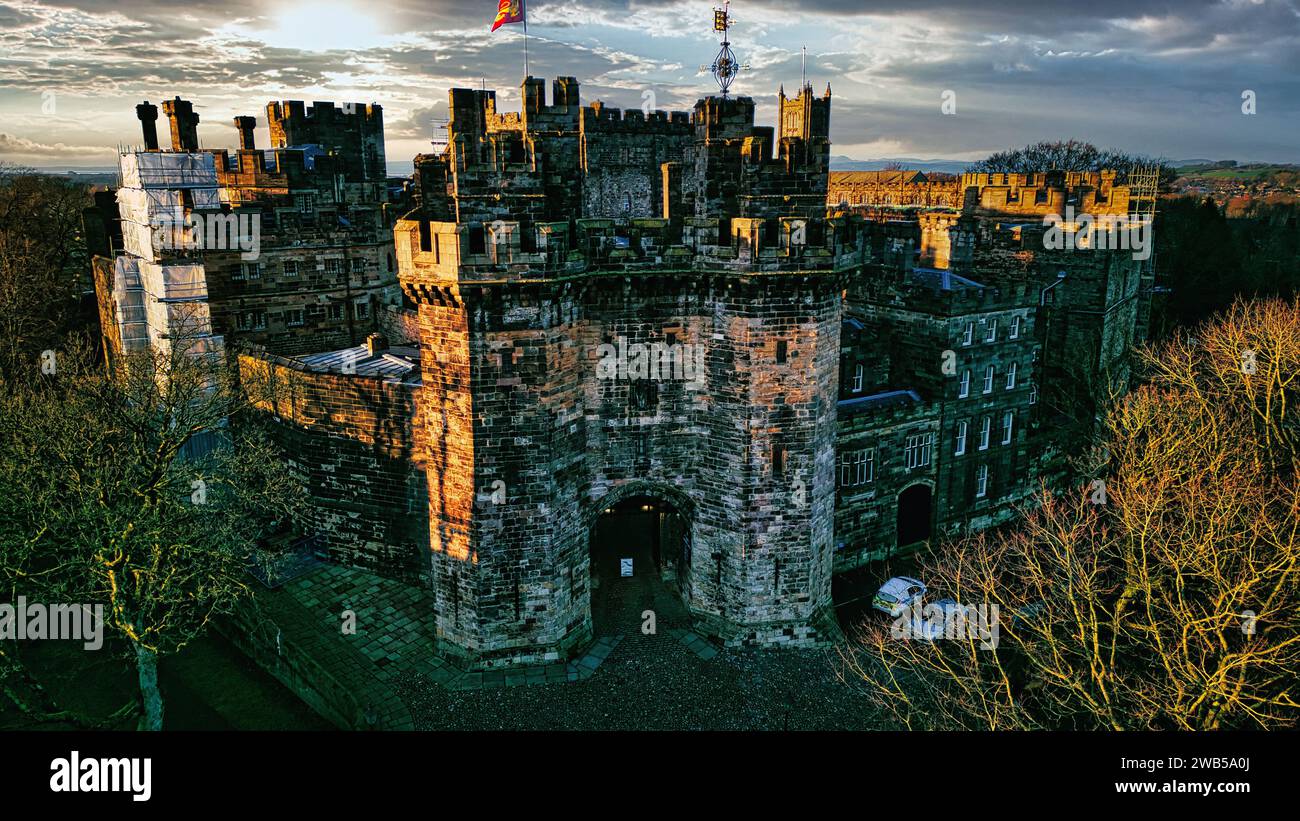 Historic medieval Lancaster castle at sunset with vibrant sky and lush ...