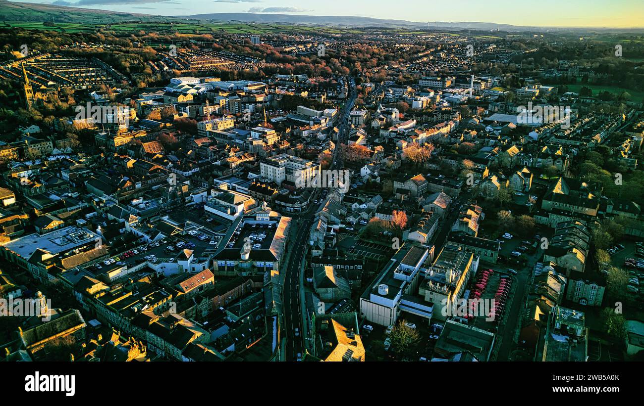 Aerial view of a cityscape at sunset with warm lighting, showcasing ...