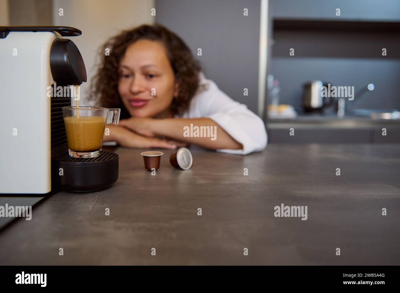 Details on a transparent glass cup with freshly brewed espresso coffee ...