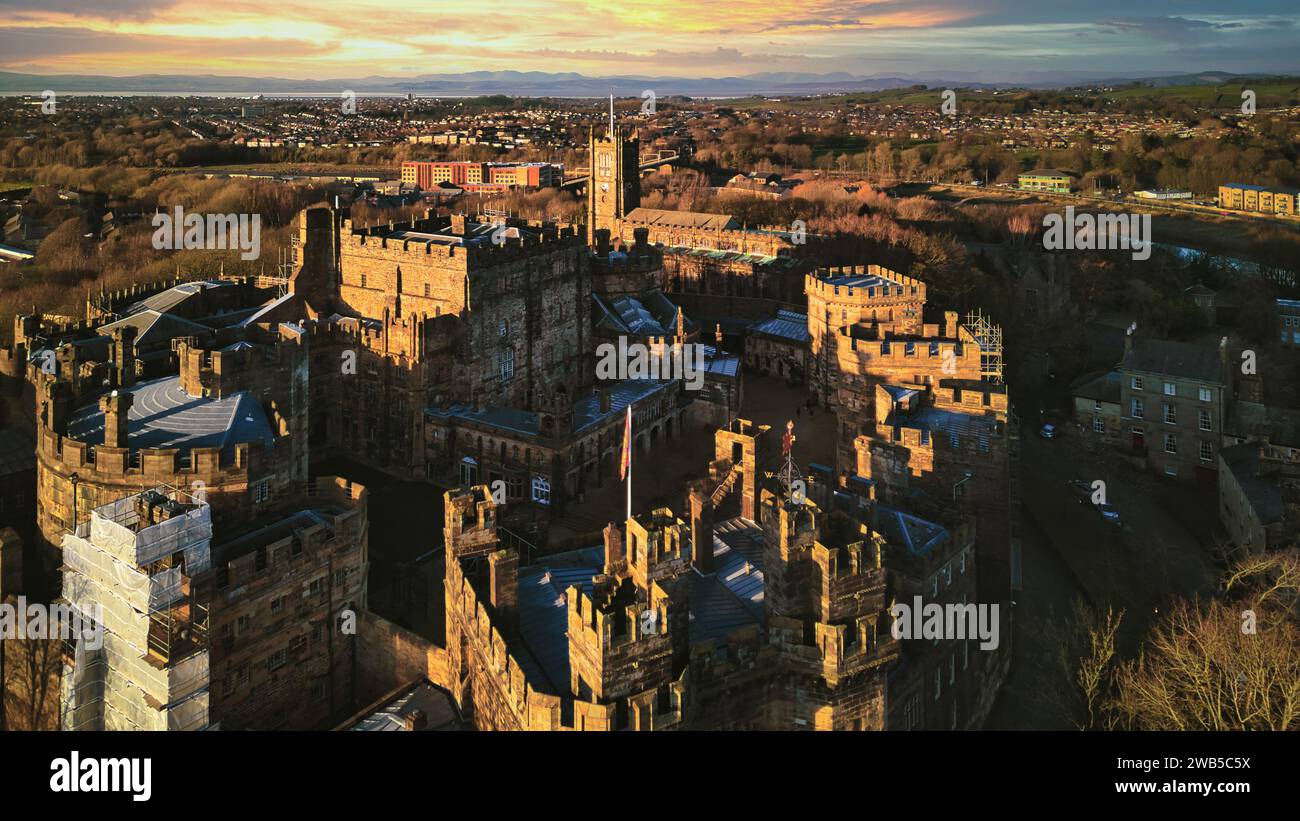Aerial view of a historic castle at sunset with surrounding landscape ...