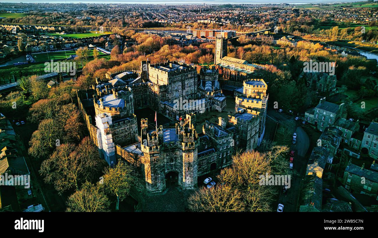 Aerial view of the Lancaster Castle amidst lush trees during sunset ...