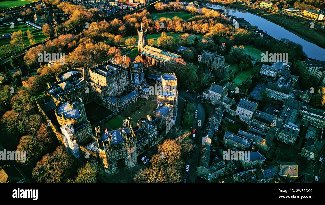 Aerial view of a historic Lancaster castle surrounded by greenery and a ...