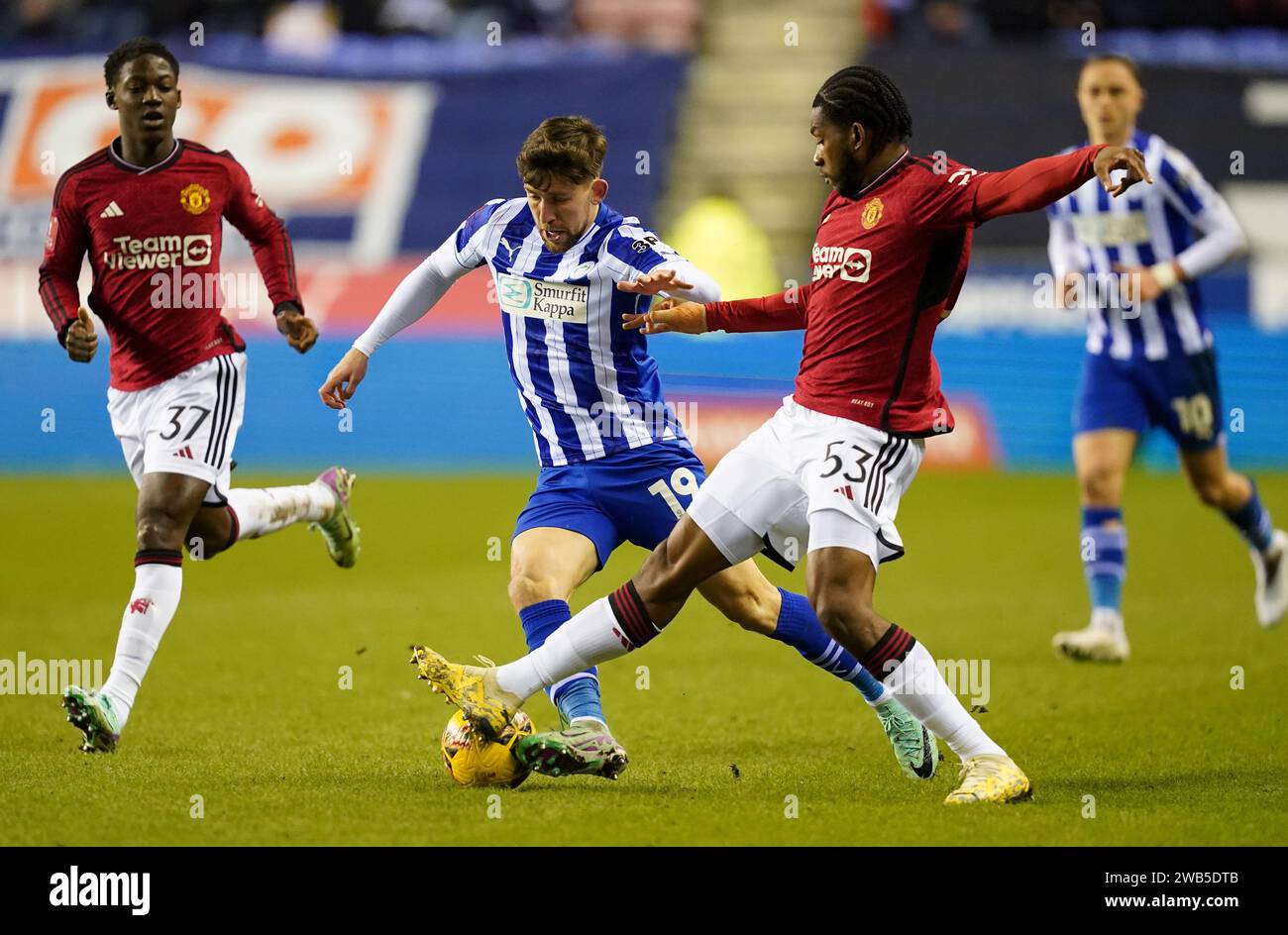 Wigan Athletic's Callum Lang (left) and Manchester United's Willy ...