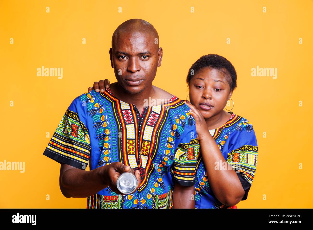 Frightened african american man and woman couple illuminating with ...