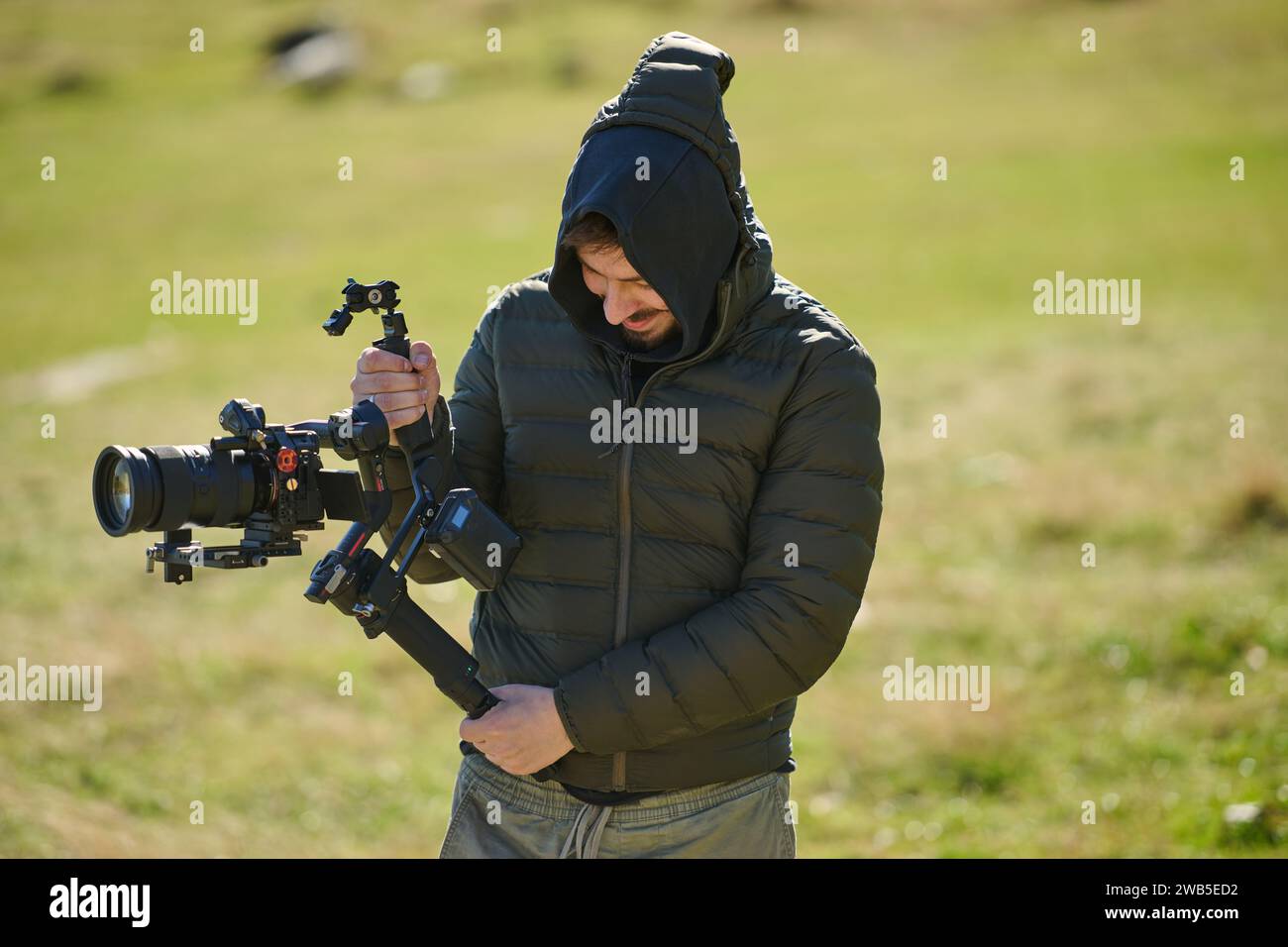 A skilled videographer, equipped with professional gear, captures the ...