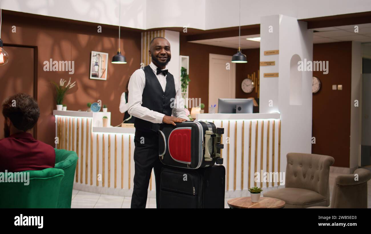 African american bellboy takes suitcases hi-res stock photography and images - Alamy
