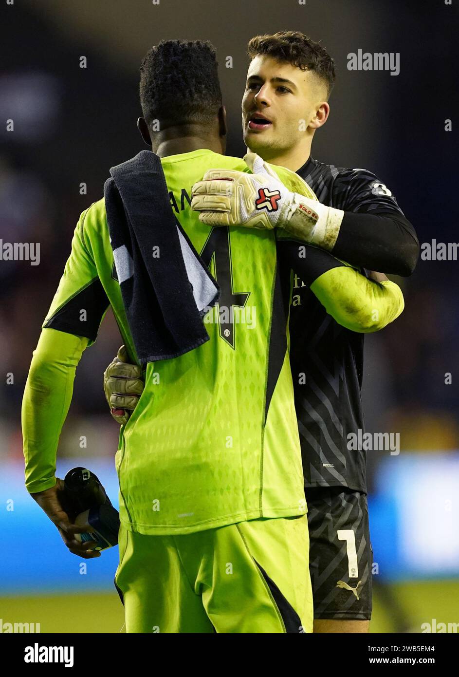 Manchester United goalkeeper Andre Onana (left) and Wigan Athletic ...