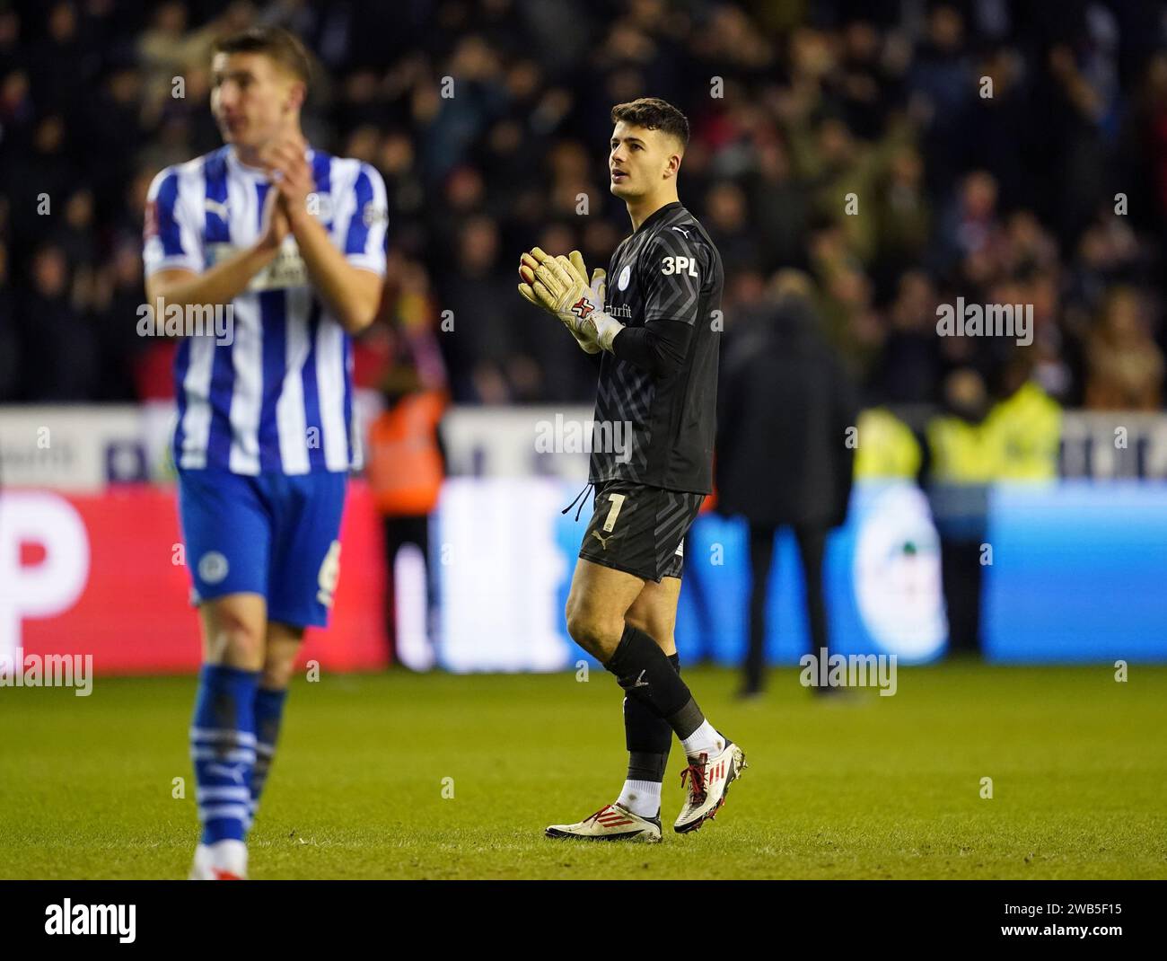 Wigan Athletic goalkeeper Sam Tickle applauds the fans after the ...