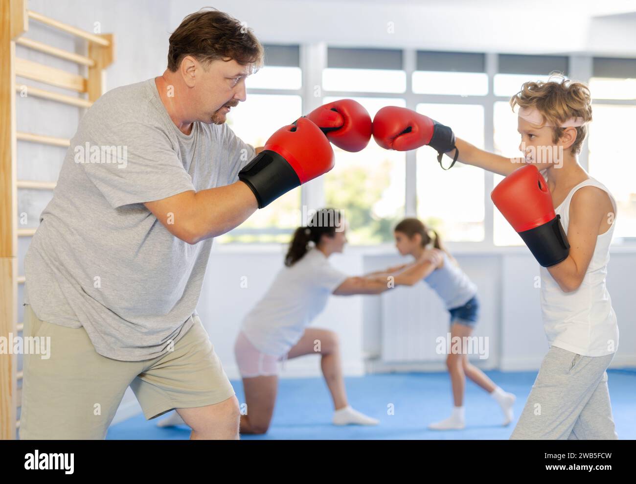 Father and son training boxing in studio Stock Photo - Alamy