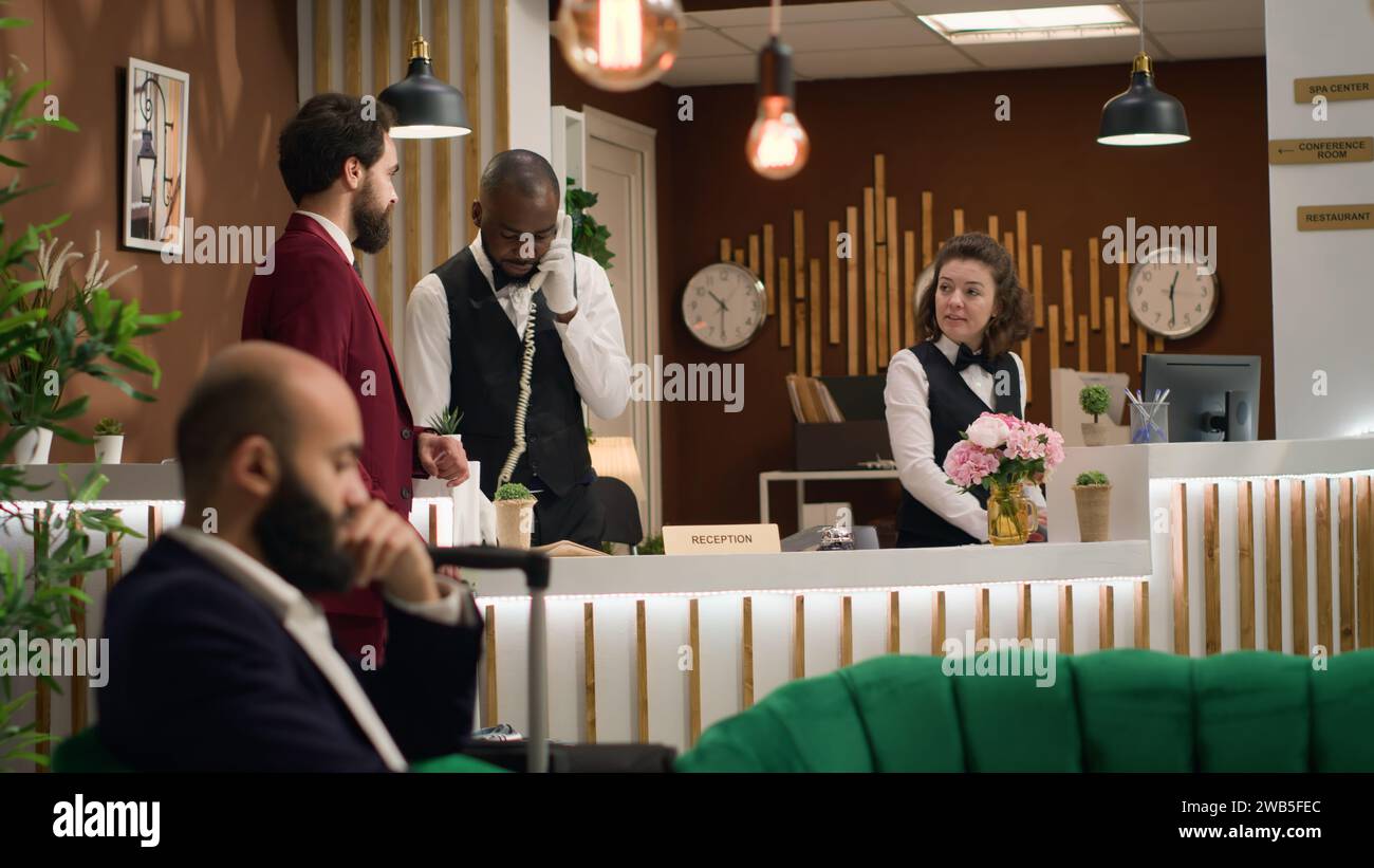 African manager talking receptionist hi-res stock photography and images - Alamy