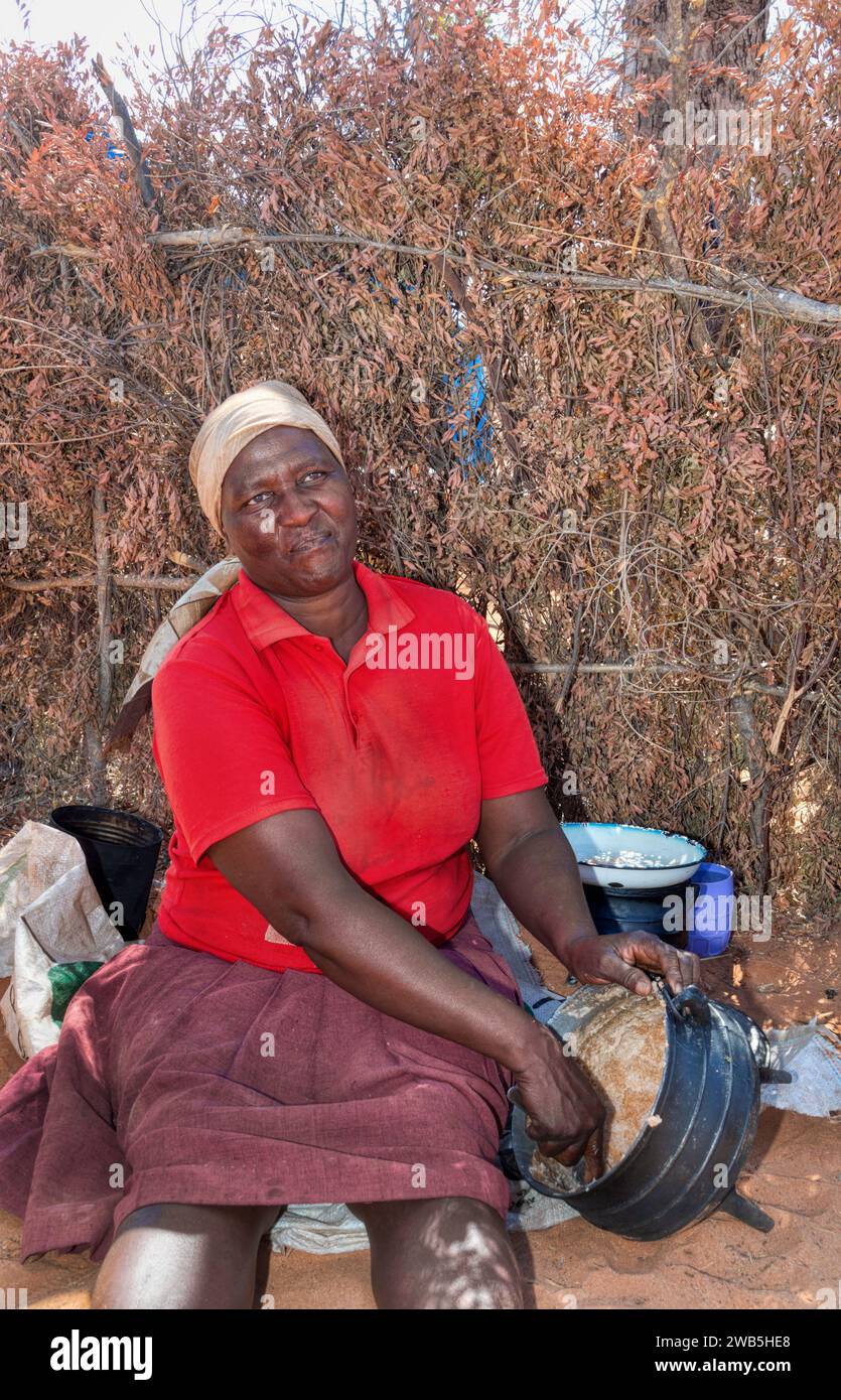 African woman , lunch time in the village ,shack ,outdoors kitchen ...