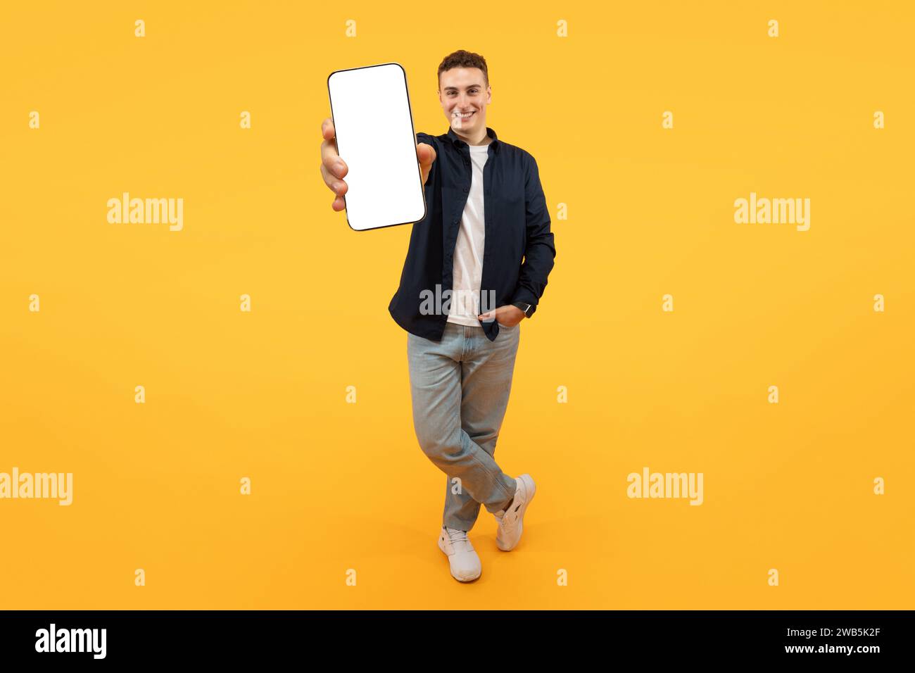 Cool young guy showing cell phone with white screen Stock Photo - Alamy