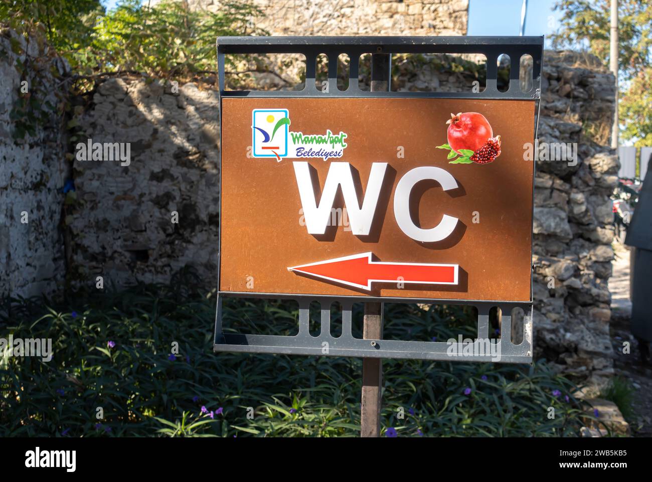 WC toilet direction sign with pomegranate sticker Stock Photo - Alamy