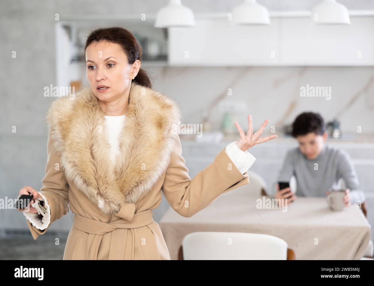 Mother leaving son home alone Stock Photo - Alamy