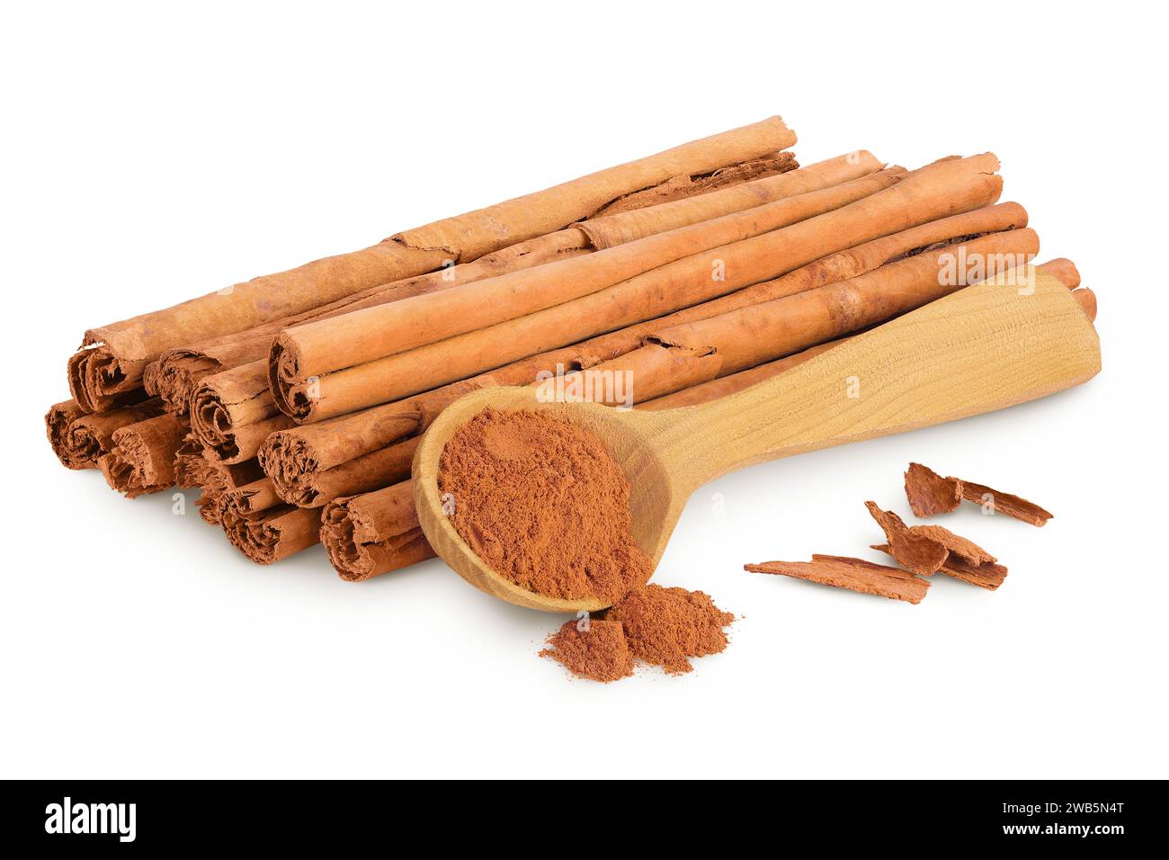 Cinnamon sticks with powder in wooden spoon isolated on white ...