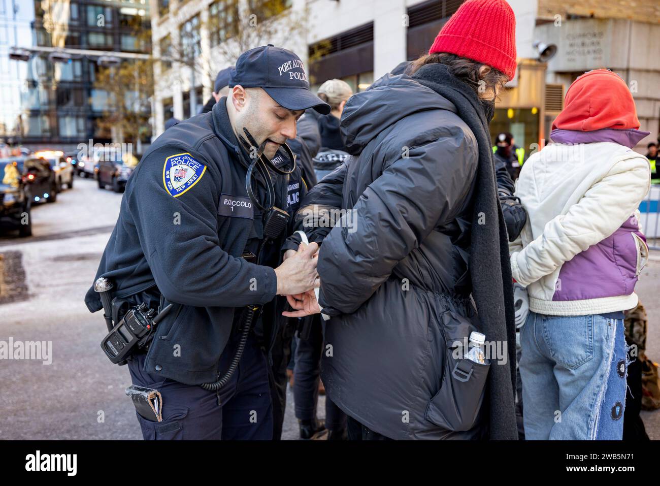 NEW YORK, NEW YORK - JANUARY 8: A police officer places handcuffs onto ...