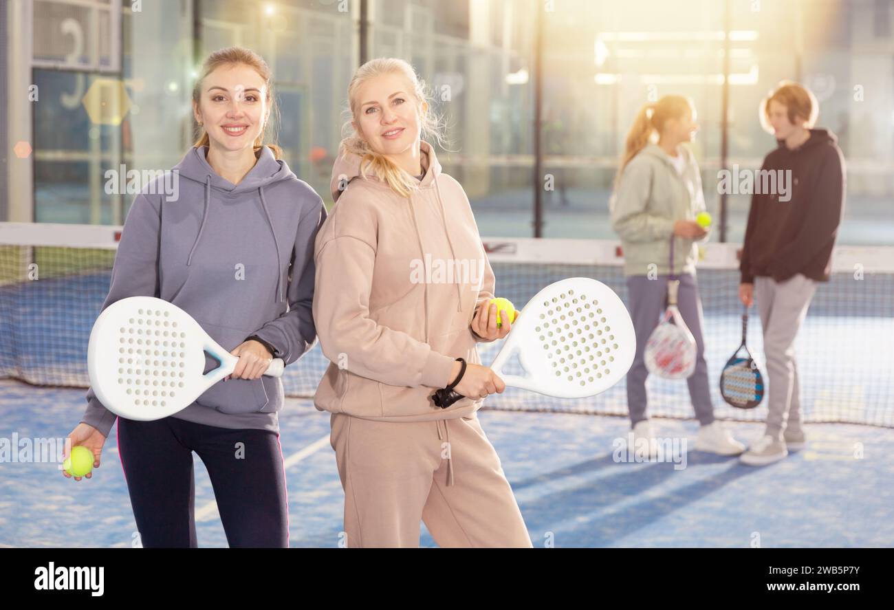 Portrait of two women with rackets and padel ball Stock Photo - Alamy