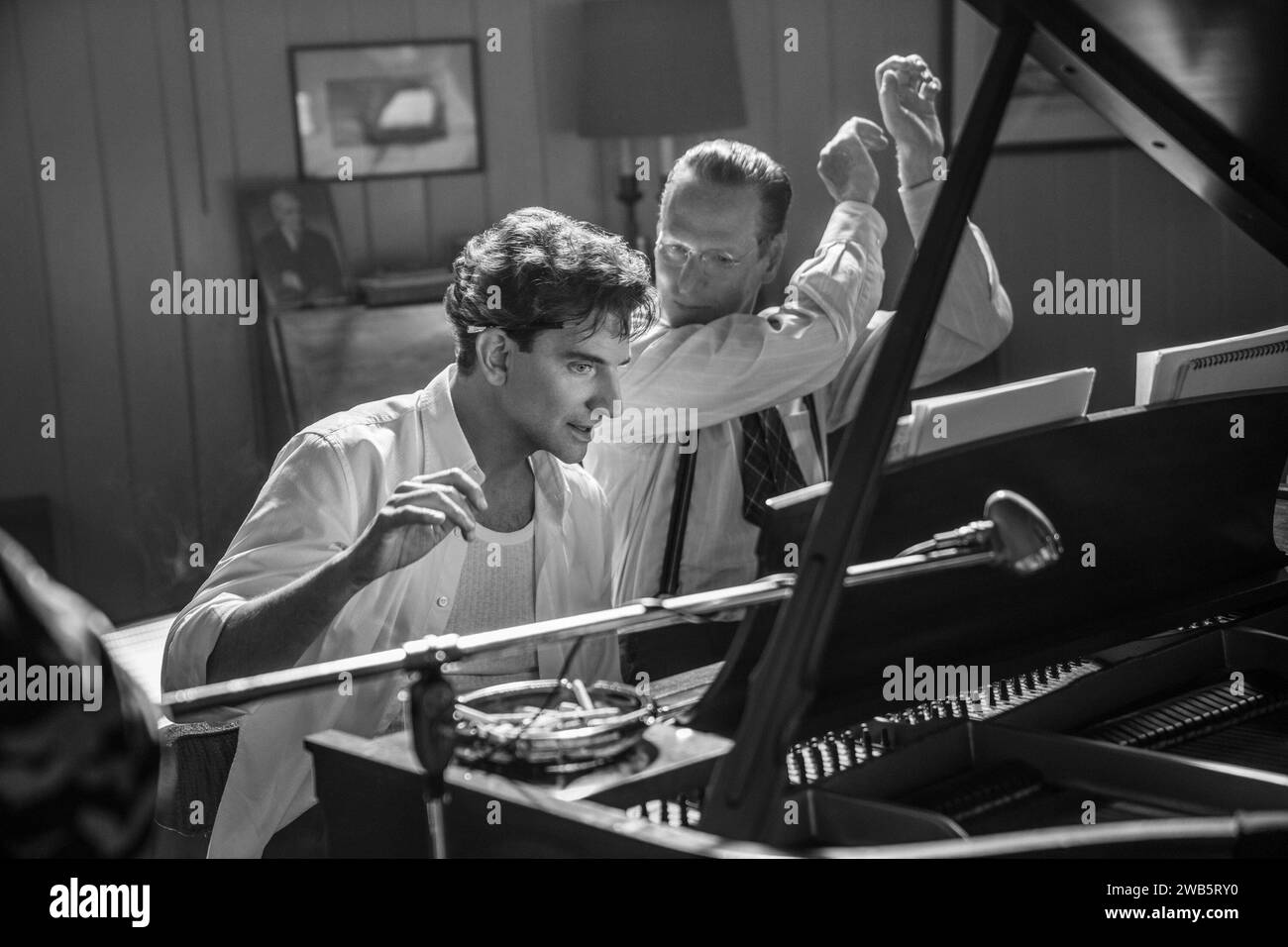 MAESTRO, from left: Bradley Cooper as Leonard Bernstein, Brian Klugman ...