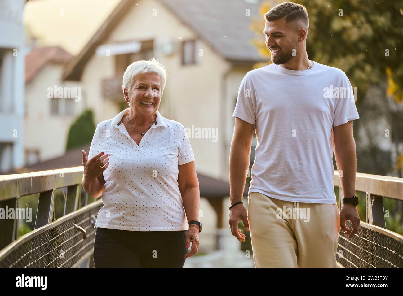 A handsome man and an older woman share a serene walk in nature ...