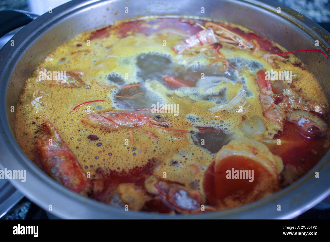 A culinary odyssey unfolds as a pot brims with the essence of the sea ...