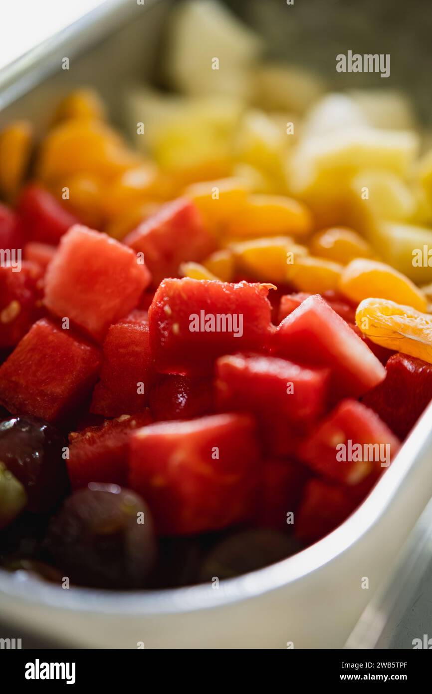 The fresh fruits are sliced in small sizes and ready to serve Stock ...