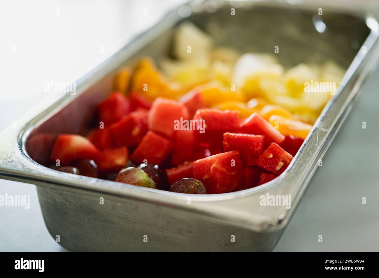 The fresh fruits are sliced in small sizes and ready to serve Stock ...