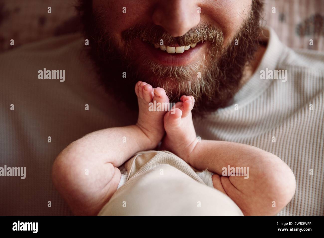 newborn baby feet touching smiling new dads beard Stock Photo - Alamy