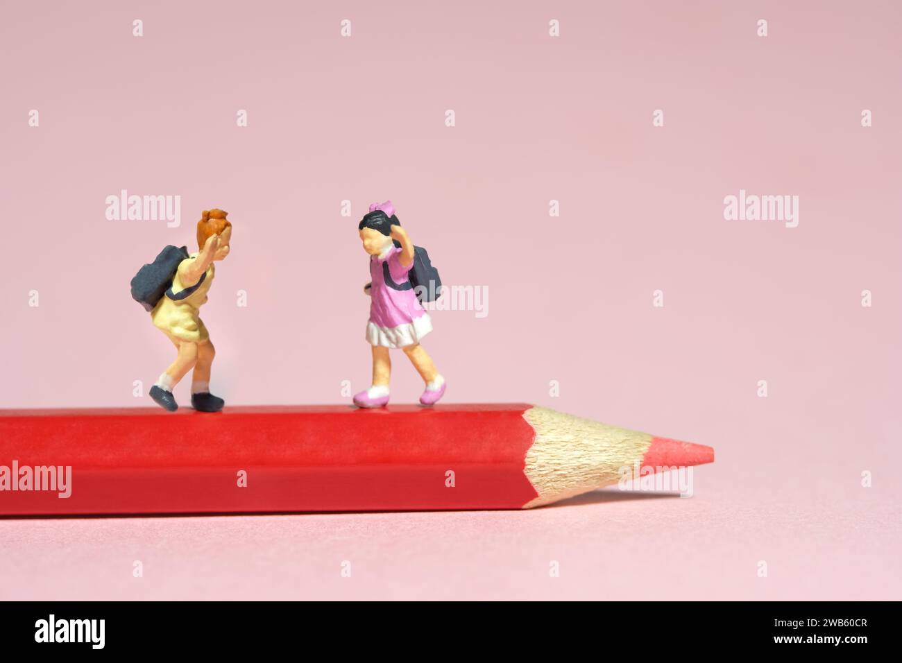 Miniature tiny people toys photography. Two kids standing above red ...