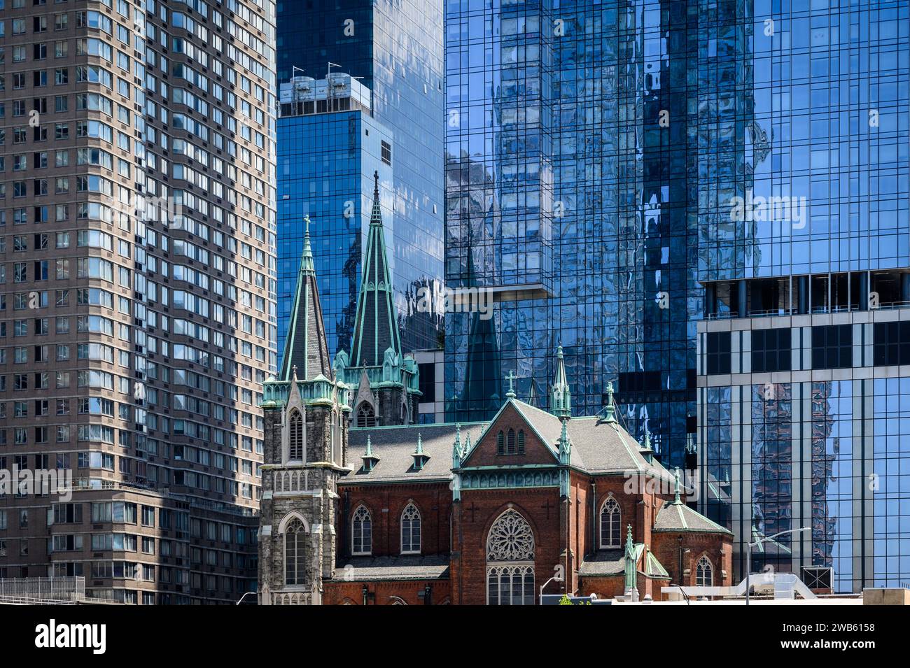 Contrast of an old church with the modern glass skyscrapers of the new ...