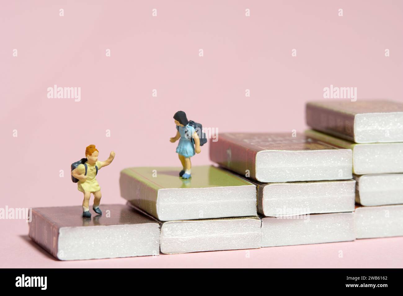 Miniature tiny people toy photography. Two girl students with school ...